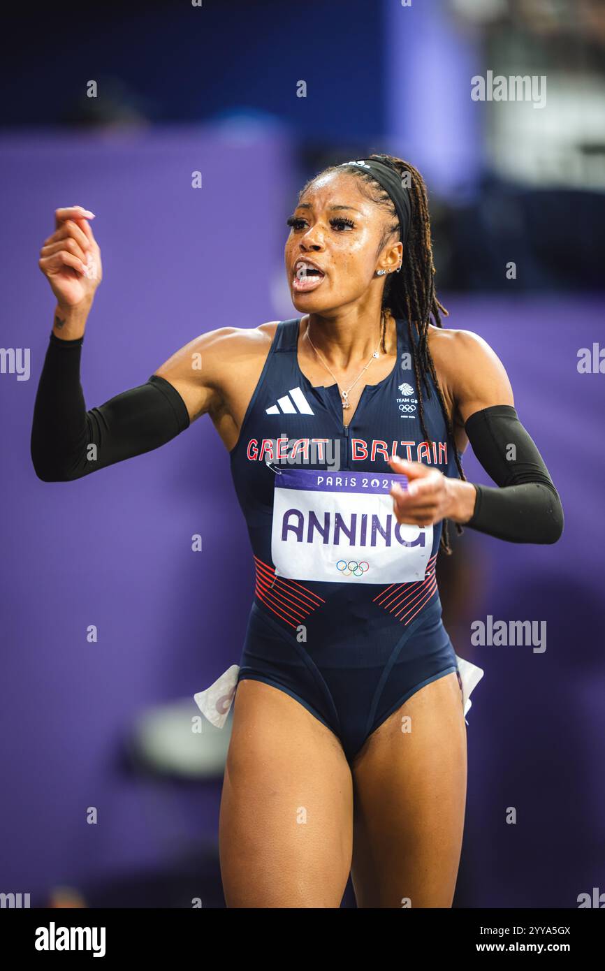 Amber Anning celebrating with her country's flag in the 4x400 meters ...