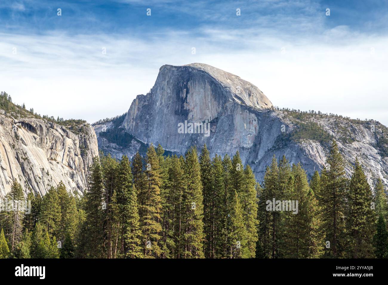 Half Dome stands tall amidst the serene landscape of Yosemite National Park, inviting ...