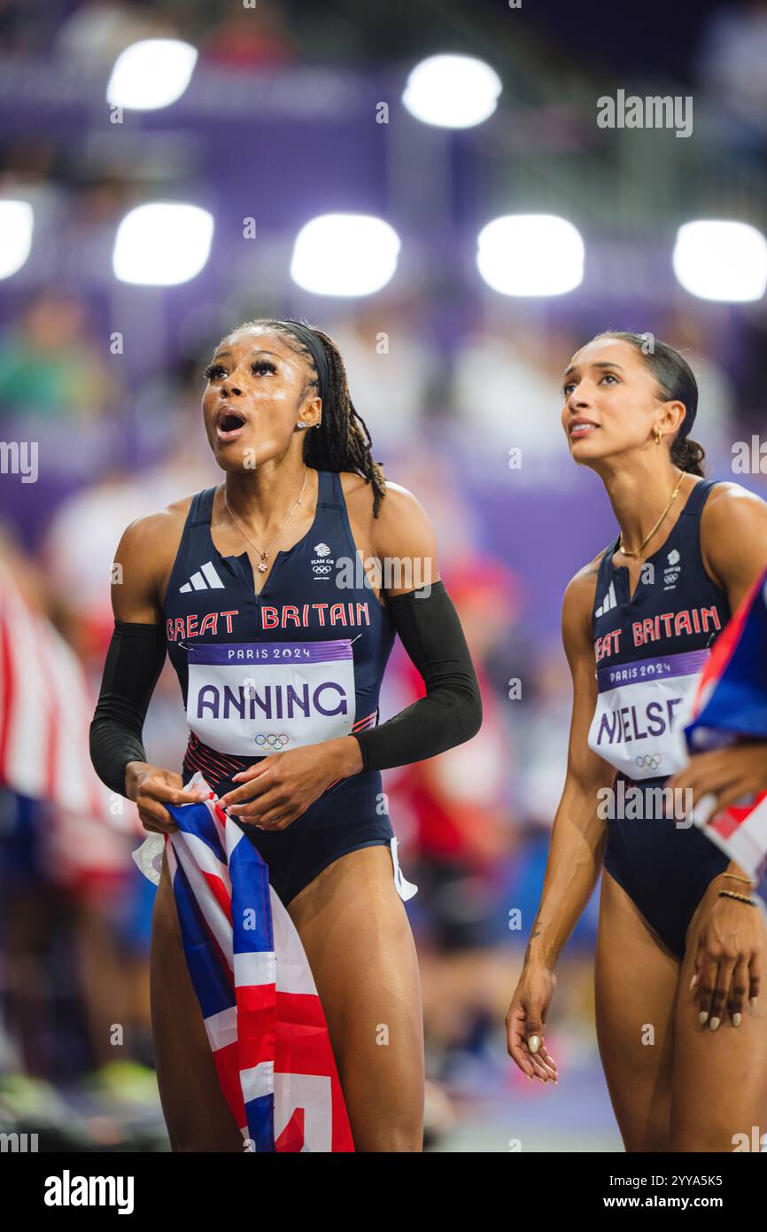 Amber Anning celebrating with her country's flag in the 4x400 meters ...