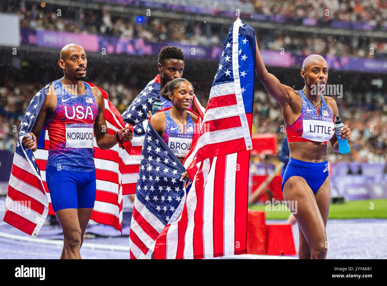 Shamier Little celebrating with her country's flag in the 4x400 meters ...