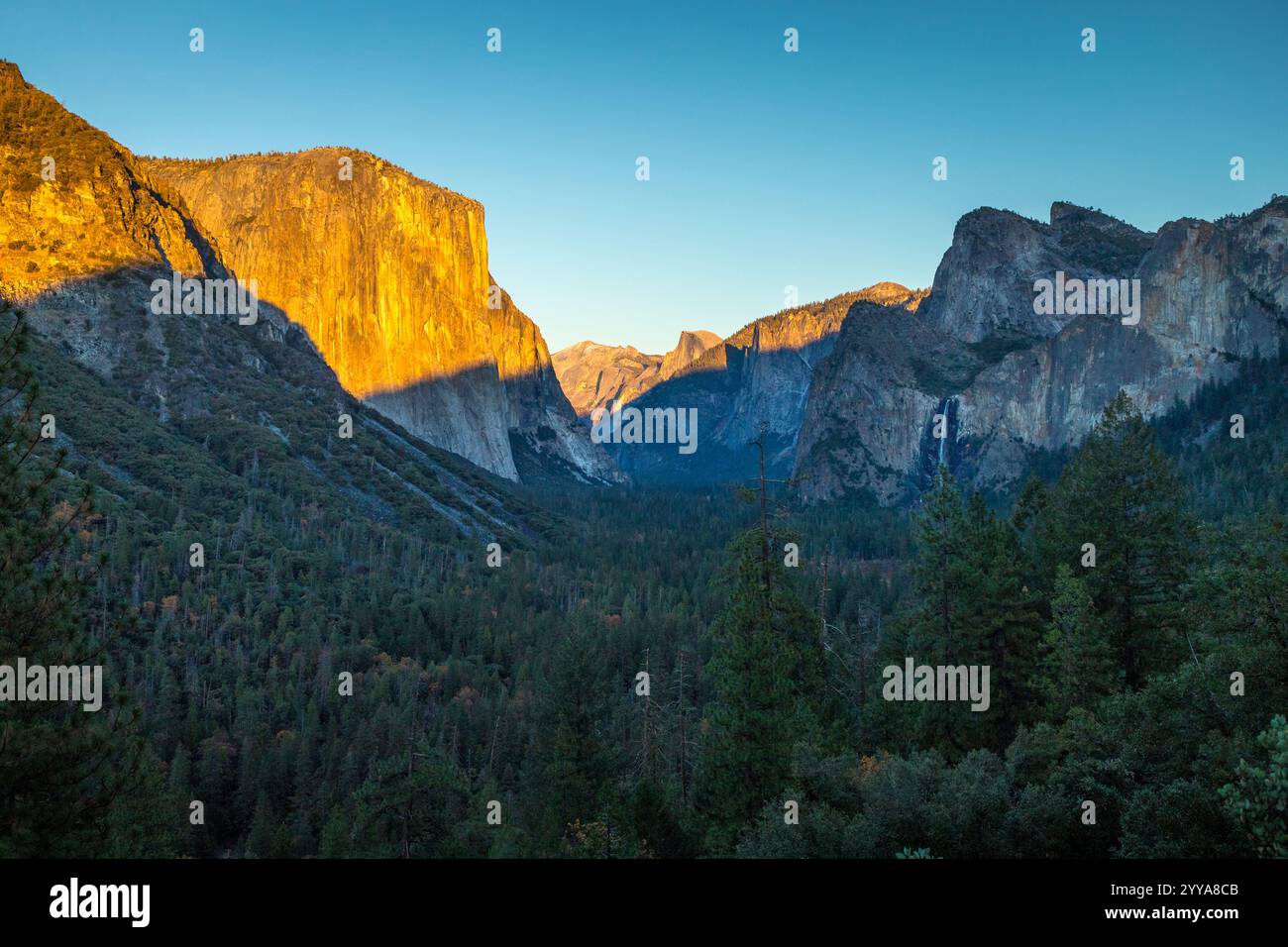 Dusk casts a warm glow on El Capitan as shadows creep across Yosemite Valley, highlighting the ...