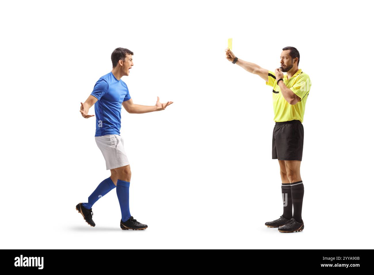 Referee running with a yellow card towards an angry football player ...