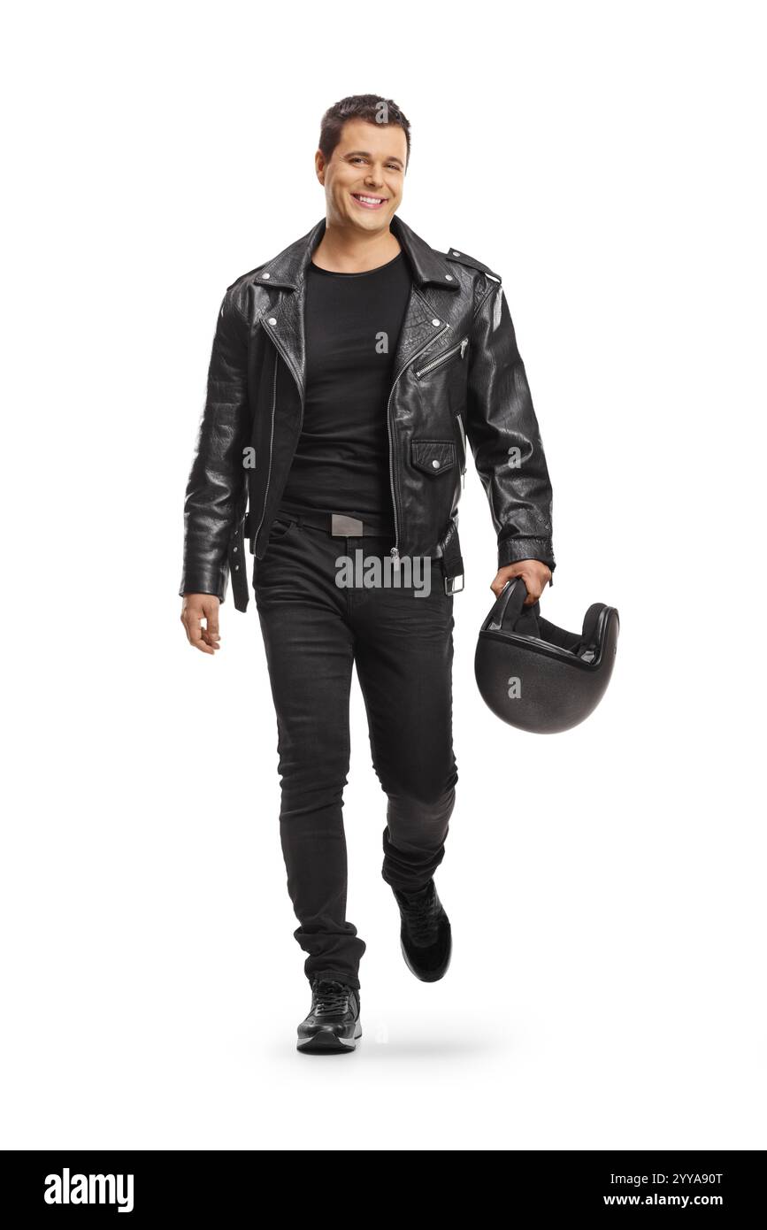Man in leather jacket holding a motorbike helmet and walking towards ...