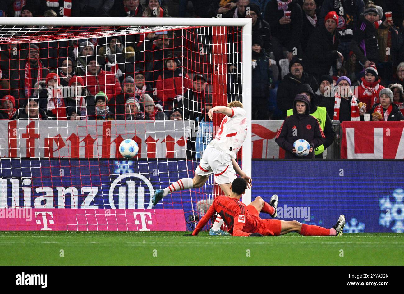 Munich's Jamal Musiala, on the ground, scores during the Bundesliga soccer match between Bayern ...