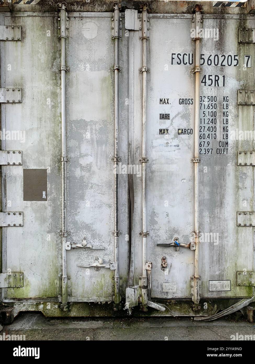 Old metal shipping container double doors, in tones of grey and white ...