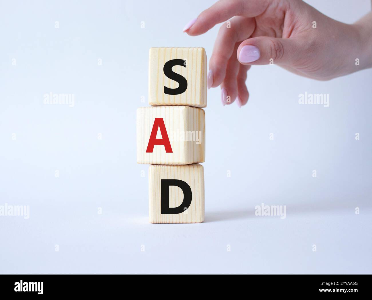 Sad symbol. Wooden cubes with words Sad. Businessman hand. Beautiful ...