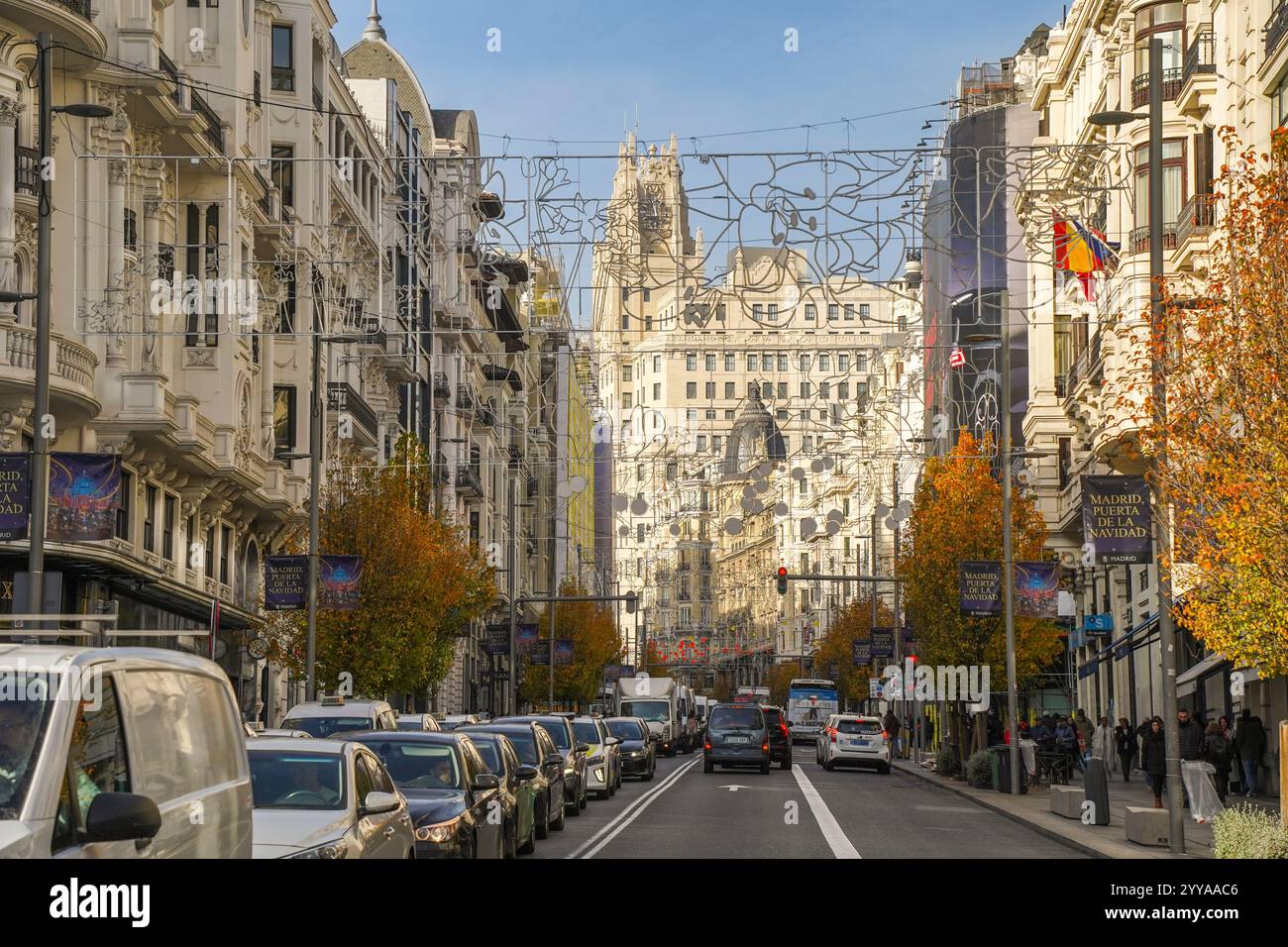 Busy traffic in a street with christmas lights at daytime in Madrid ...
