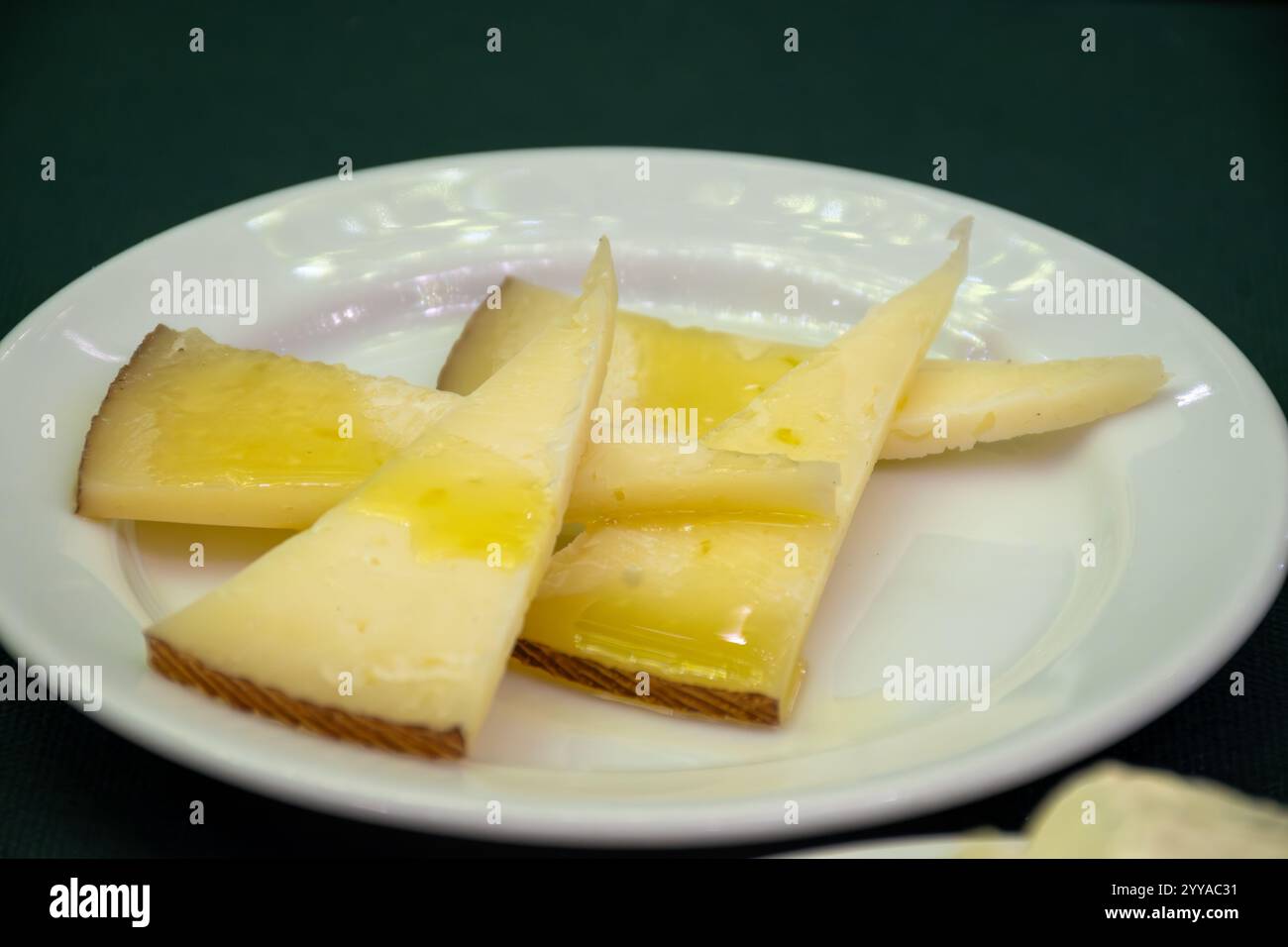 Tasting of Spanish cheeses, triangles of manchego curado cheese on ...