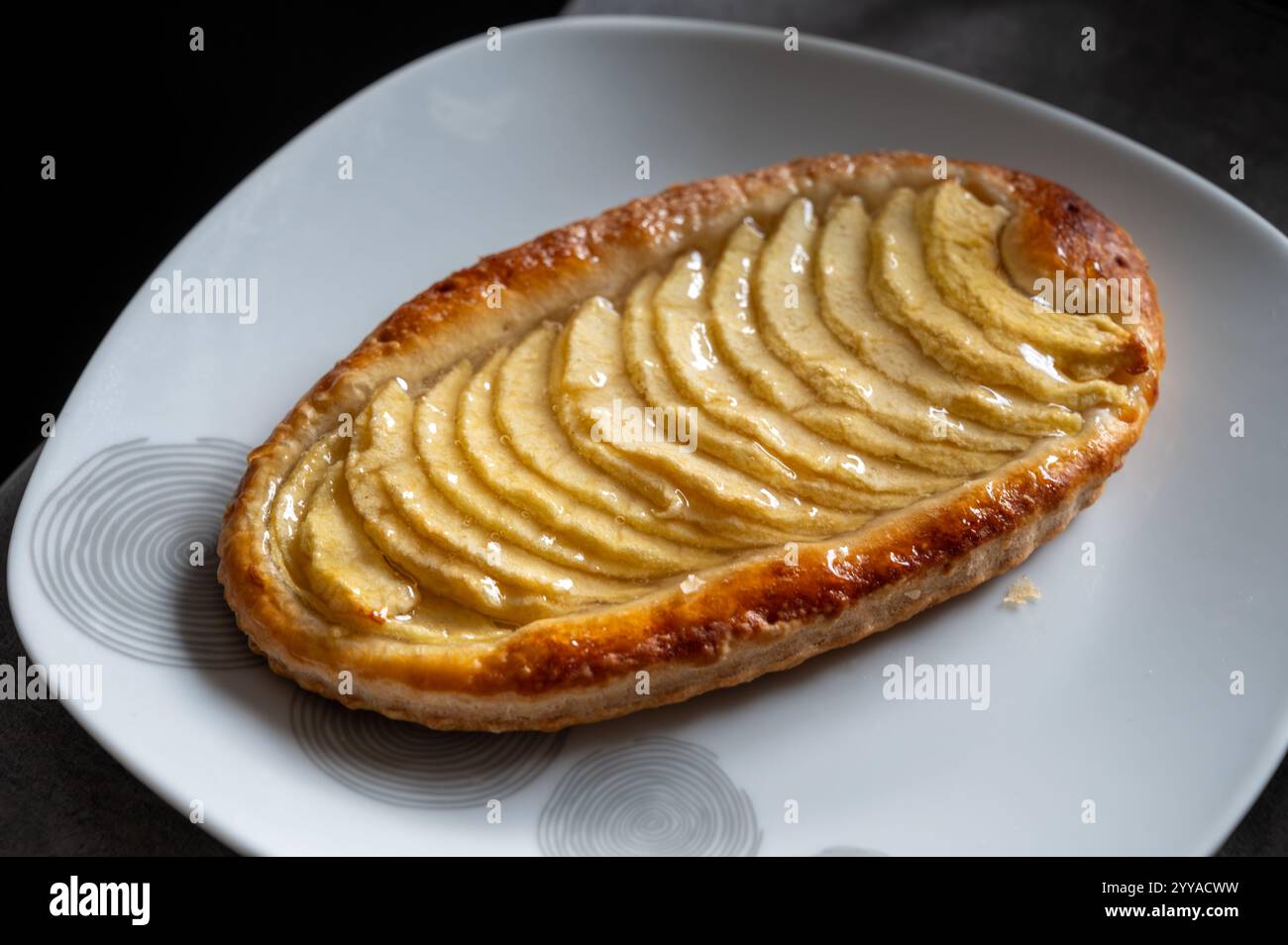 French fresh baked sweet puff pastry with fresh apple fruits in sirup ...