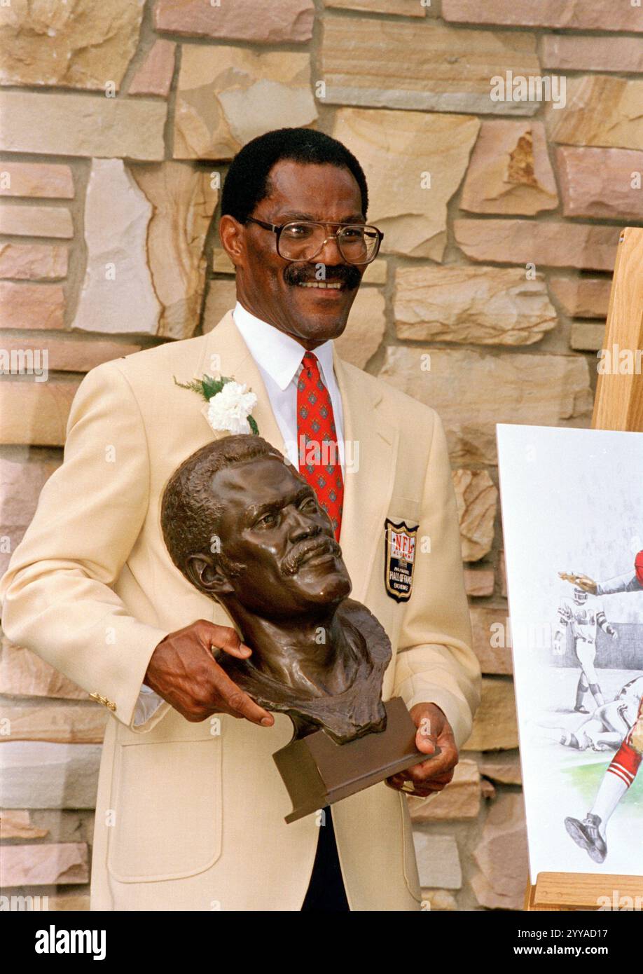 Hall of Famer Jimmie Johnson poses with his bust at the Football Hall ...