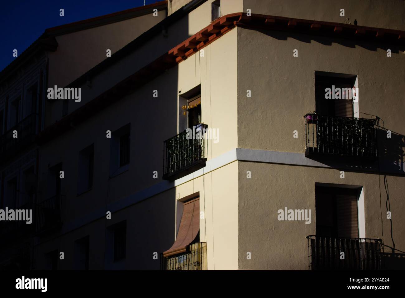 The facade of an old building corner on a European Spanish street on a ...