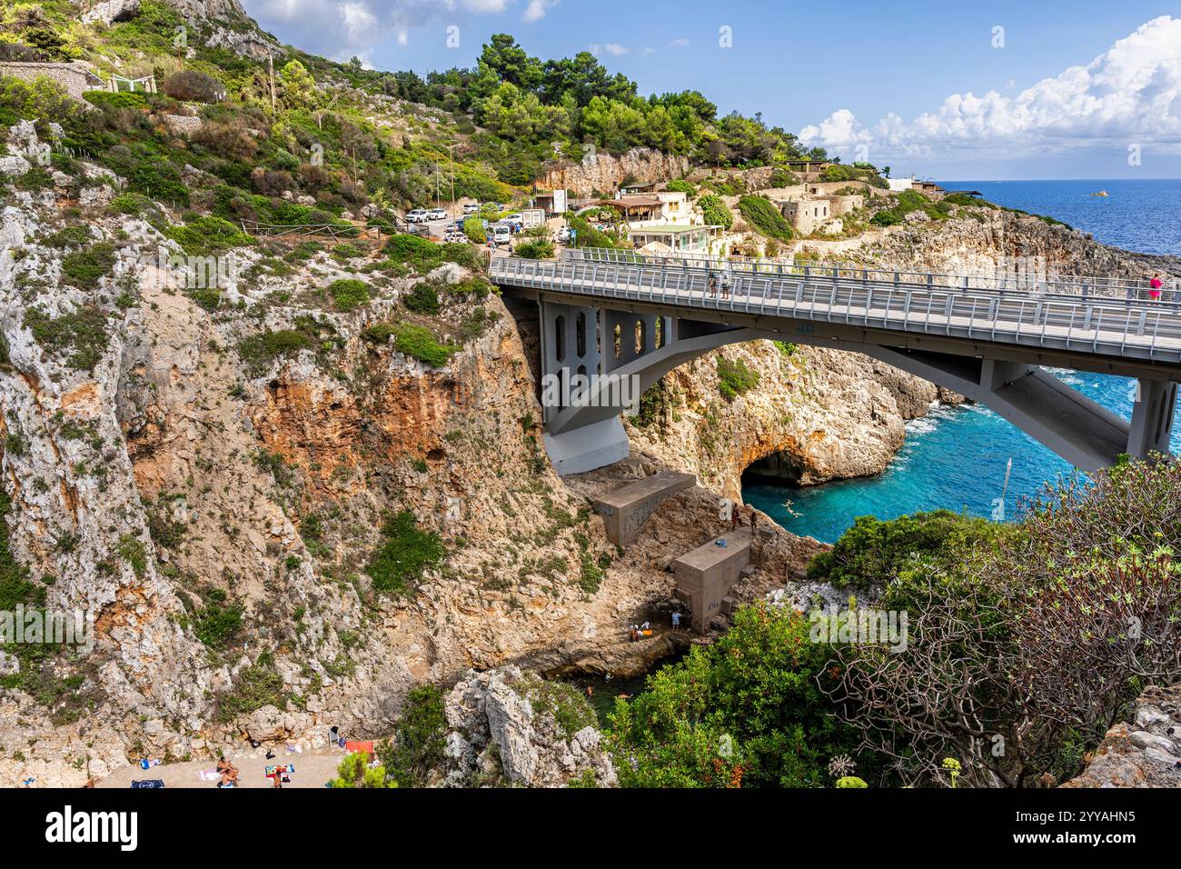 Scenic inlet called Ciolo with bathers and a concrete bridge, in the ...