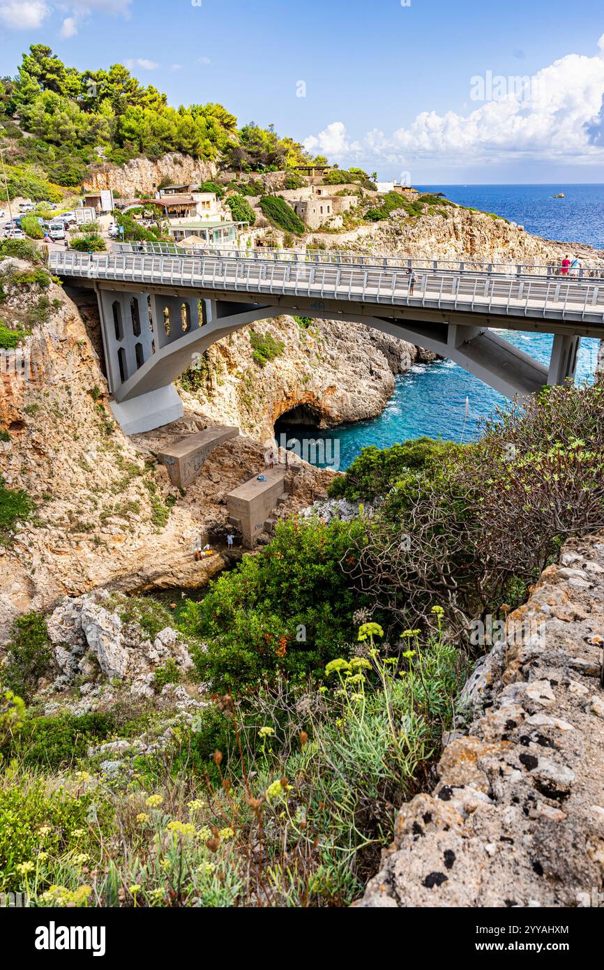 Scenic inlet called Ciolo with bathers and a concrete bridge, in the ...
