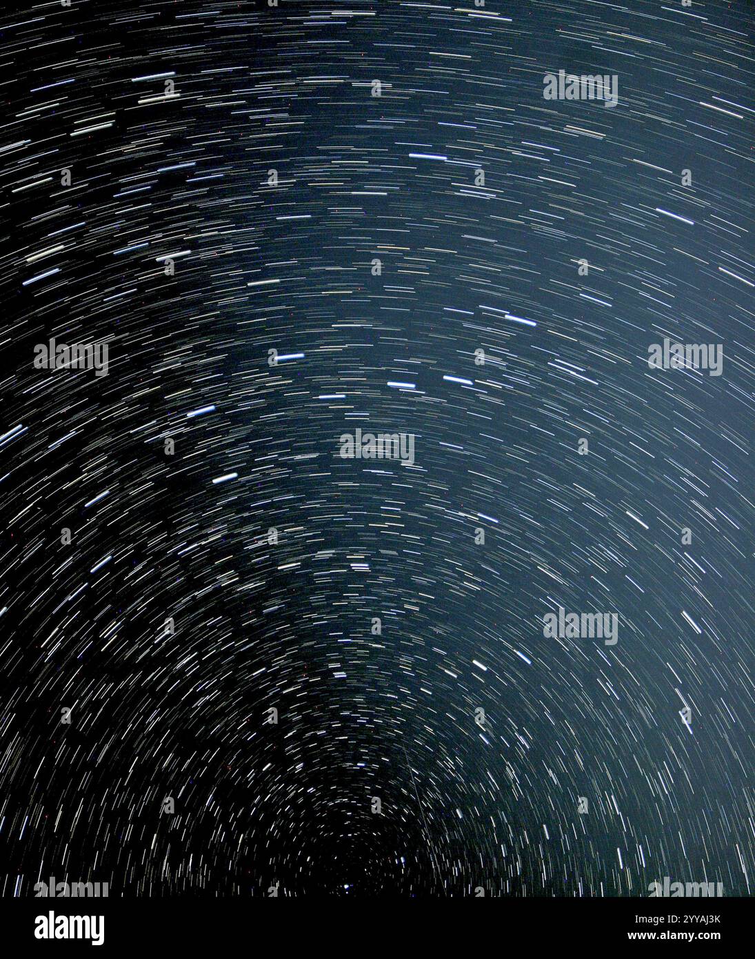 Star trails in the night sky, streaking across the background, making ...