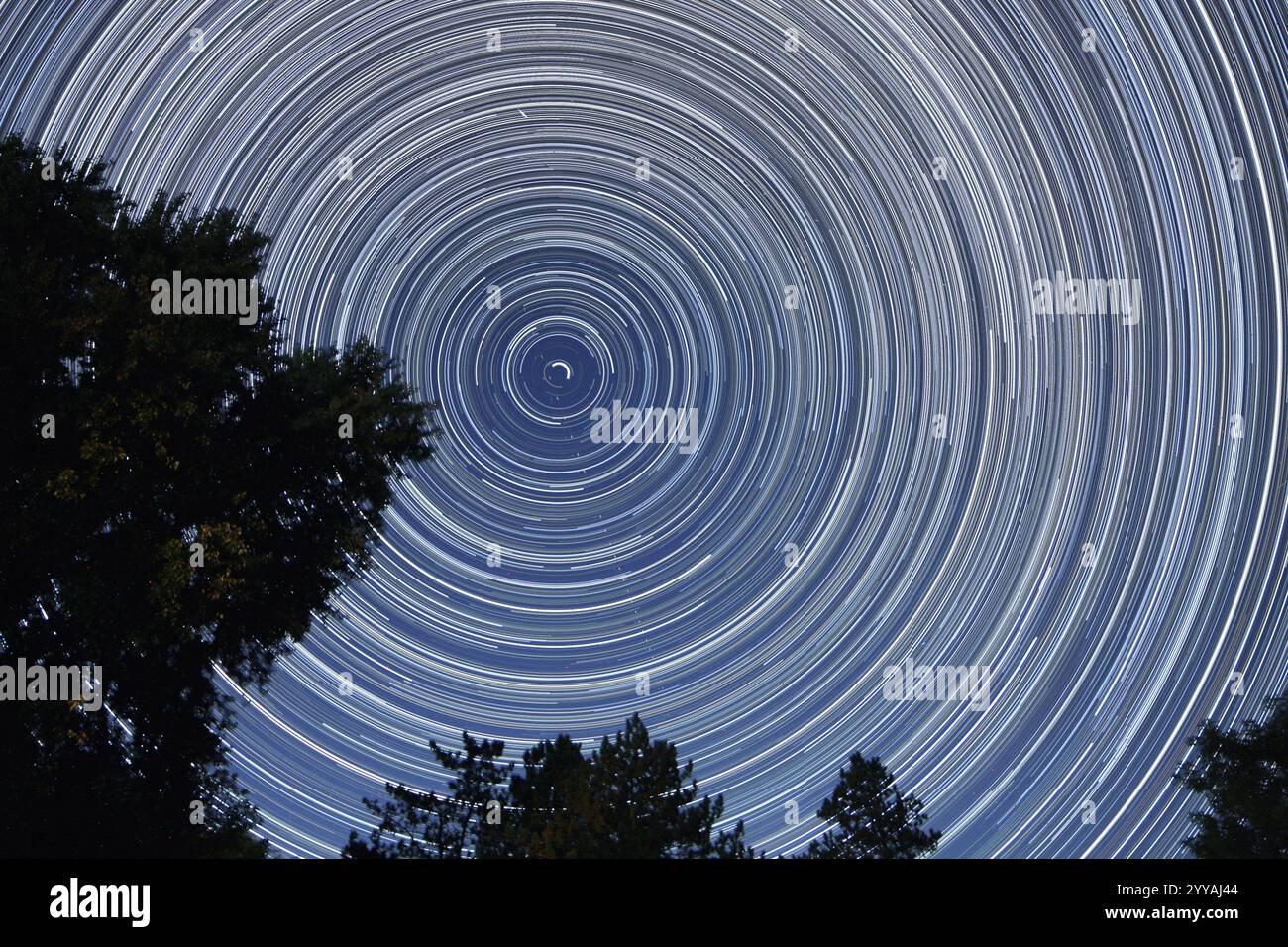 Star trails in the night sky, concentric citrcles background, making an ...