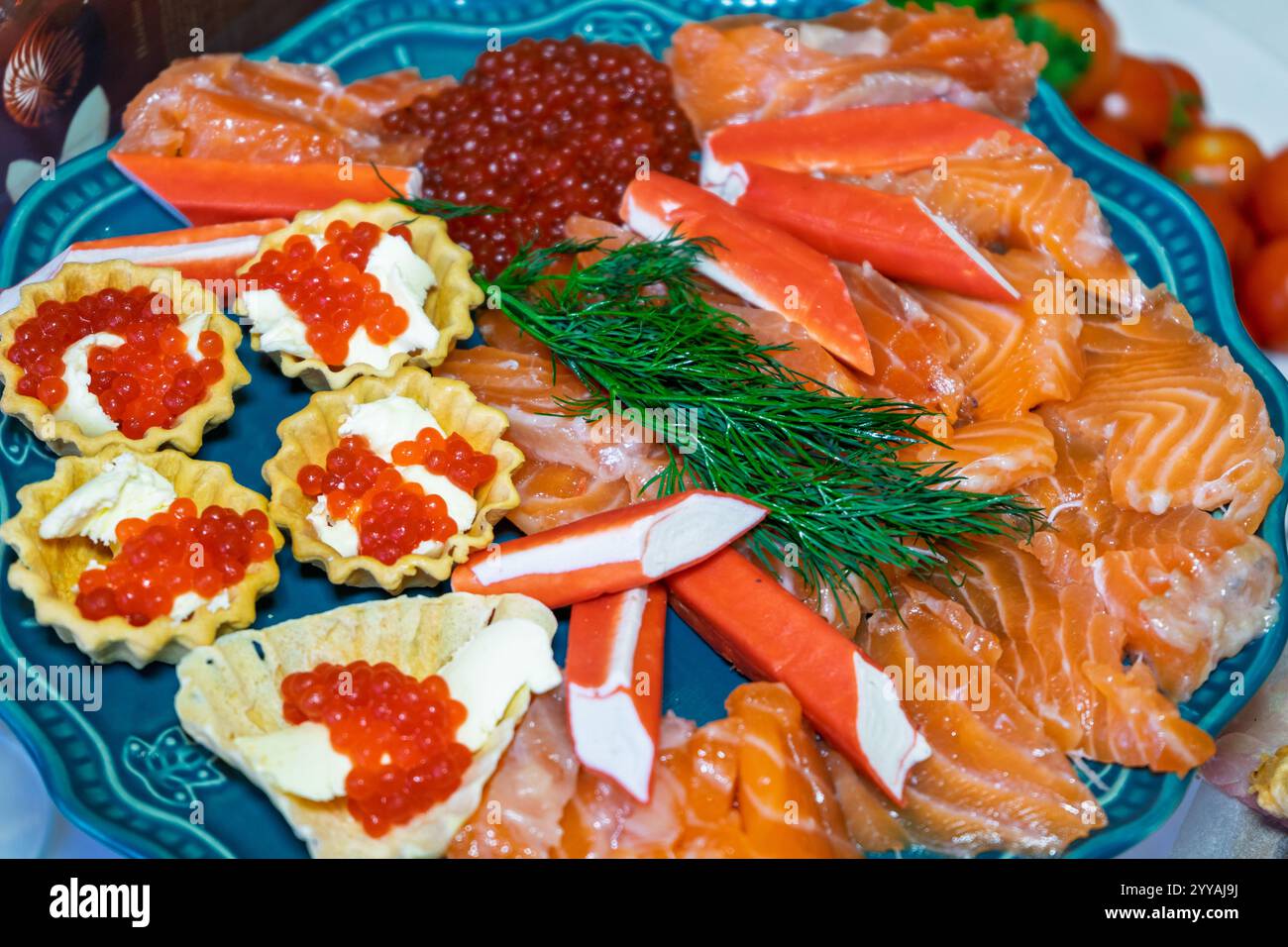 A vibrant seafood platter displays slices of fresh salmon, crab sticks ...