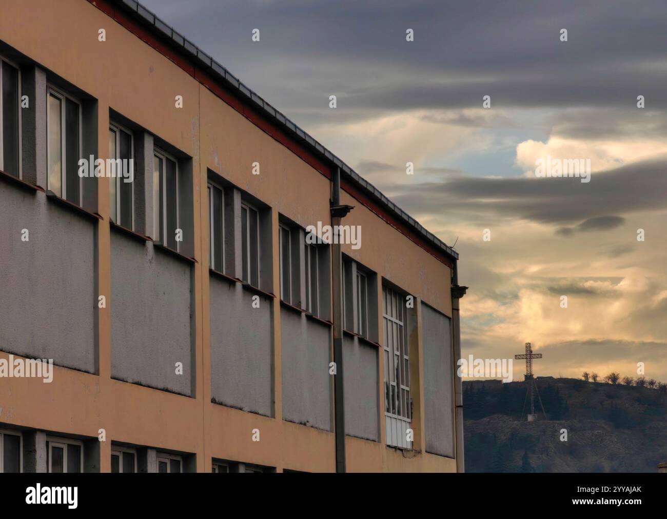 School Building and Holy Cross at Sunset Stock Photo - Alamy