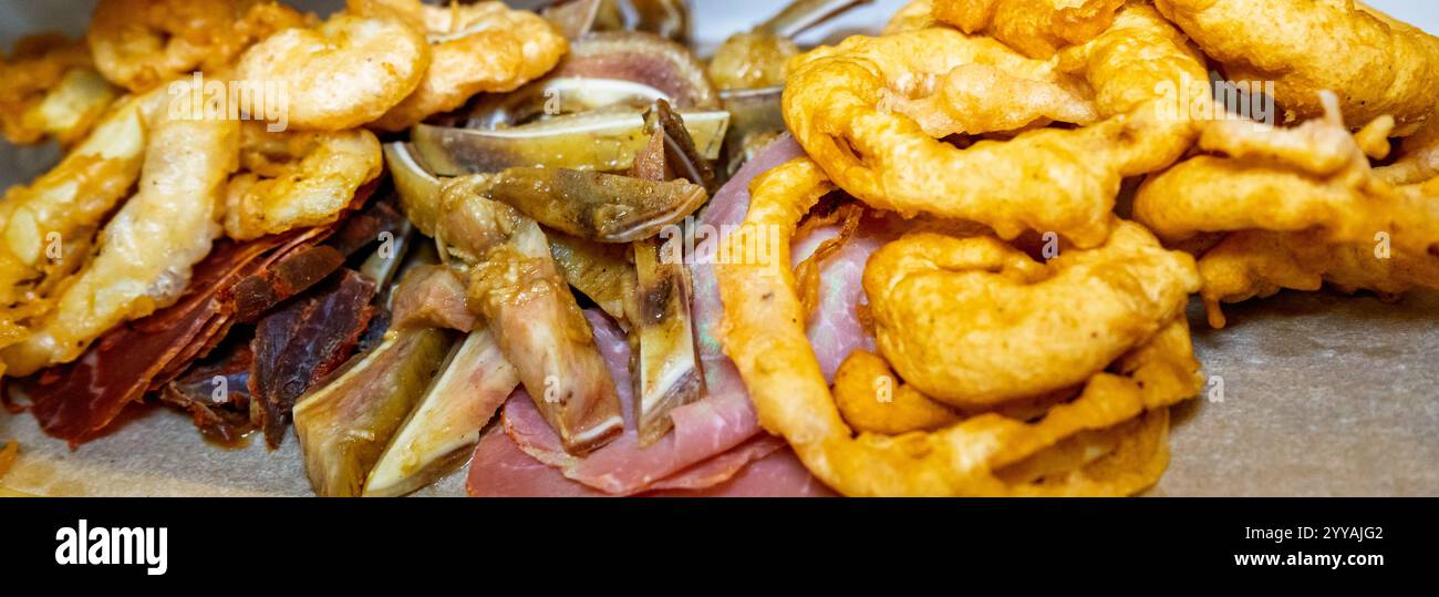 An assortment of fried snacks is arranged on a table, showcasing ...