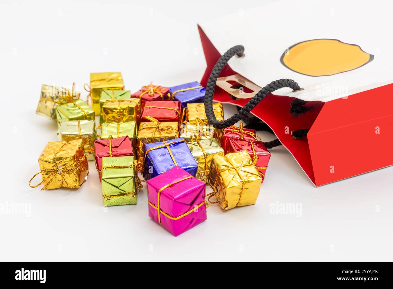 Vibrant miniature gift boxes in various colors and gold ribbons ...