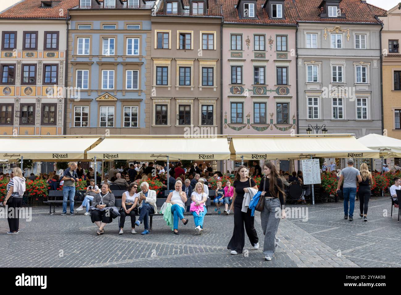 Warsaw, Poland - September 2, 2024, Tourists sit on a bench in the ...