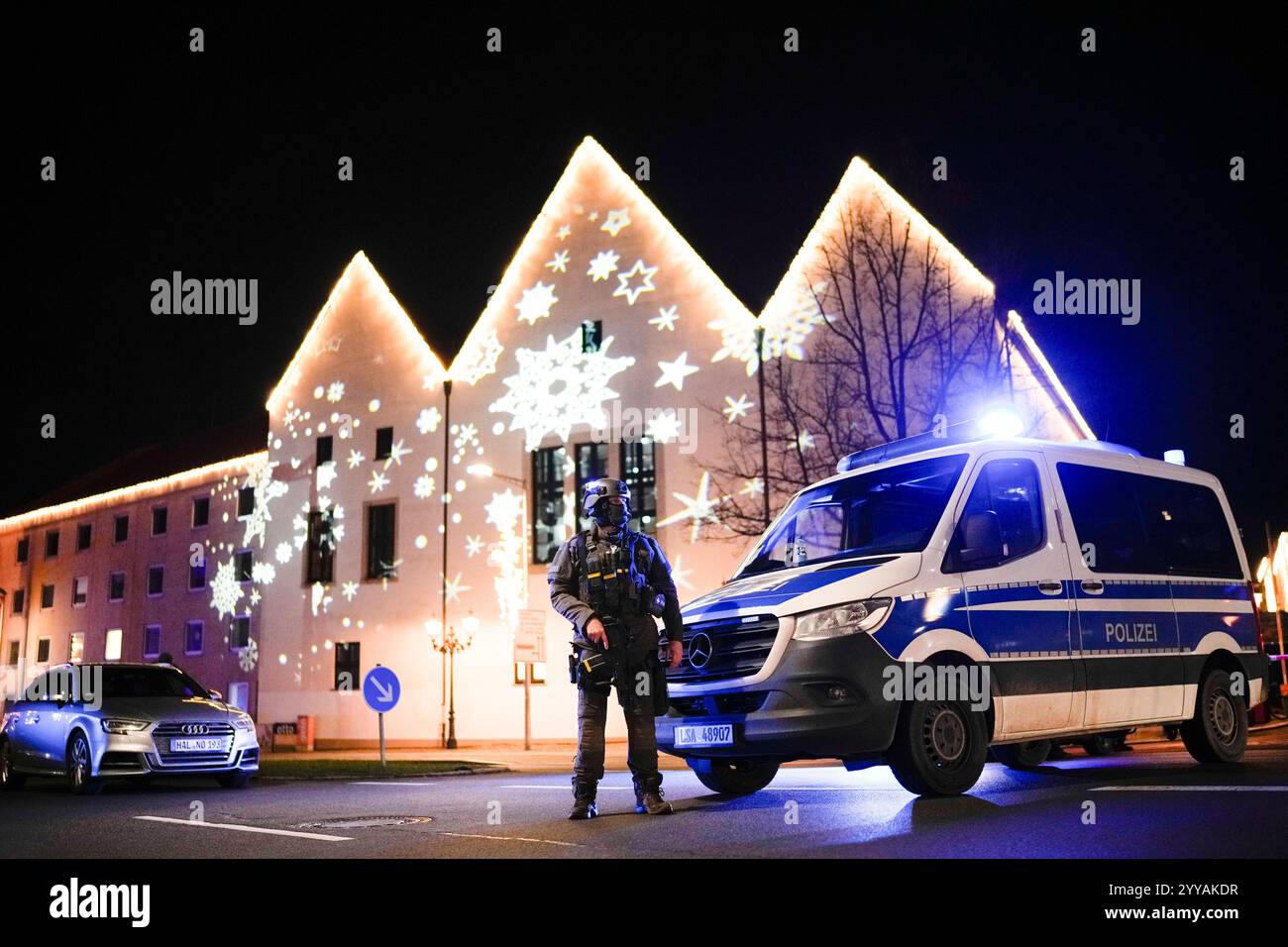 A police officer guards at a blocked road near a Christmas market after ...