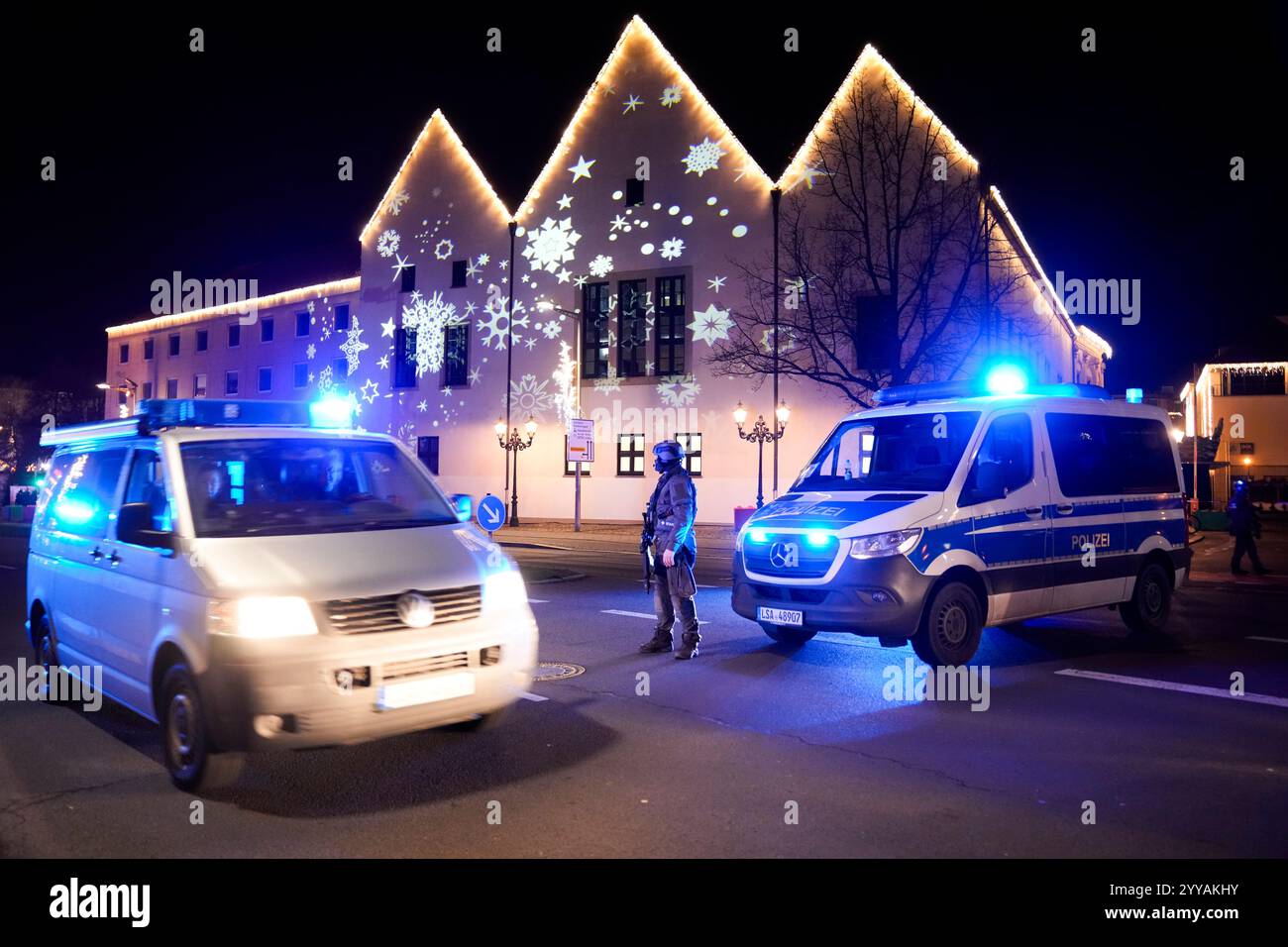 A police officer guards at a blocked road near a Christmas Market ...