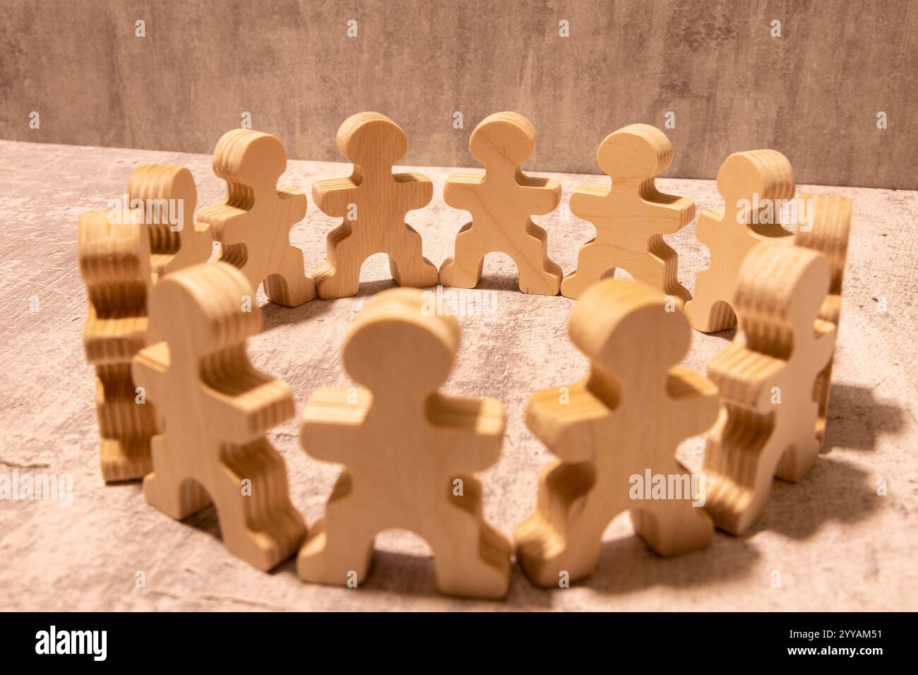 Line or stack of wooden figures symbolized a single figure amidst a ...