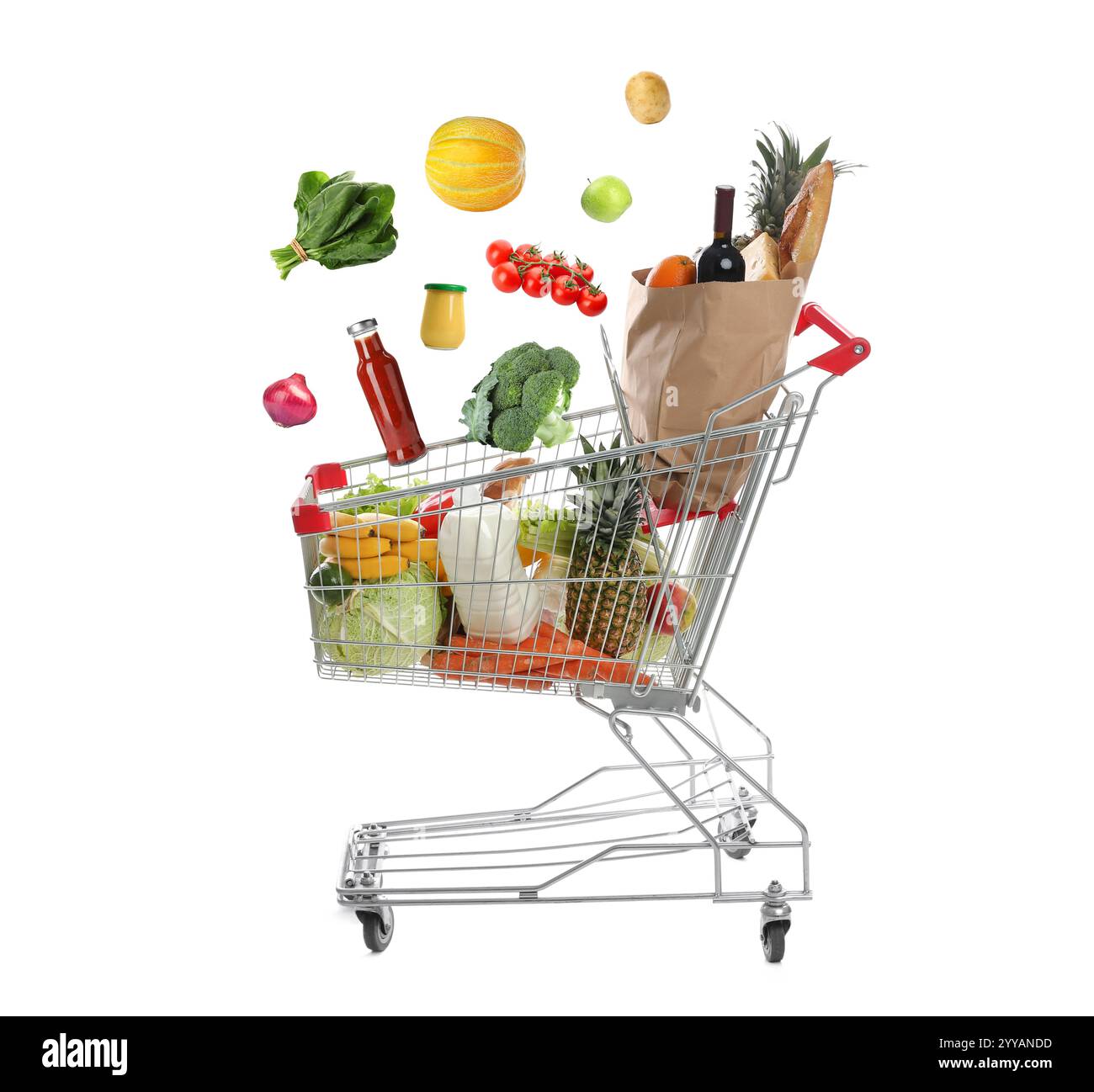 Groceries falling into shopping cart on white background Stock Photo ...
