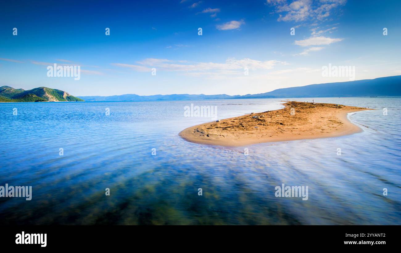 Lone small sandy island in the middle of blue sea Stock Photo - Alamy