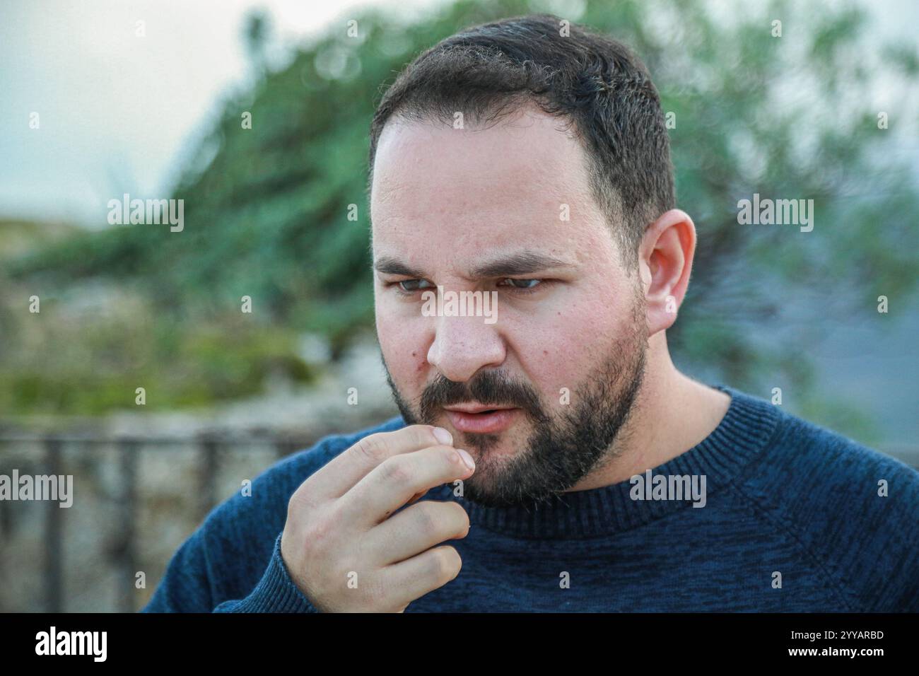 Man Struggles with Awful Biscuit Taste Stock Photo - Alamy