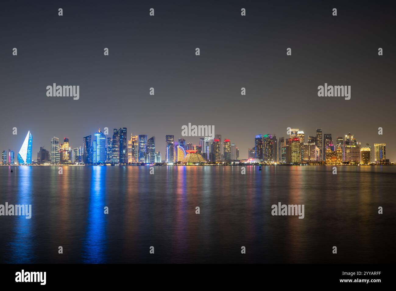 Doha city skyline illuminated at night. Qatar, Middle East Stock Photo ...