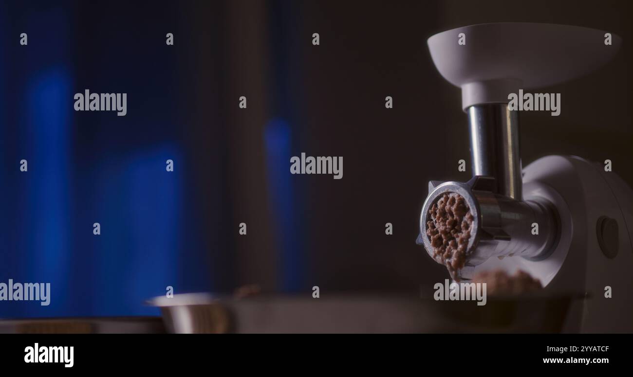 Fresh minced meat coming out of the mincer Stock Photo - Alamy