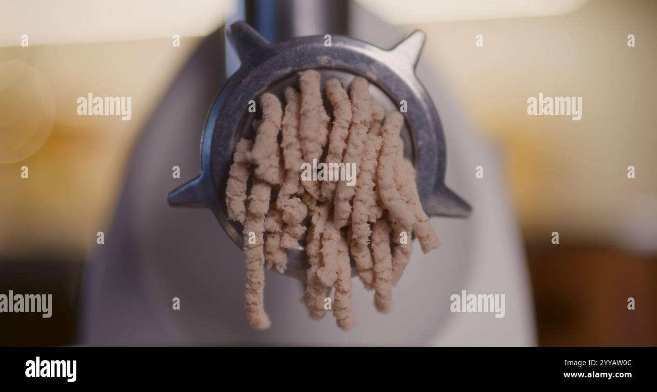 Grinding meat in electric grinder Stock Photo - Alamy