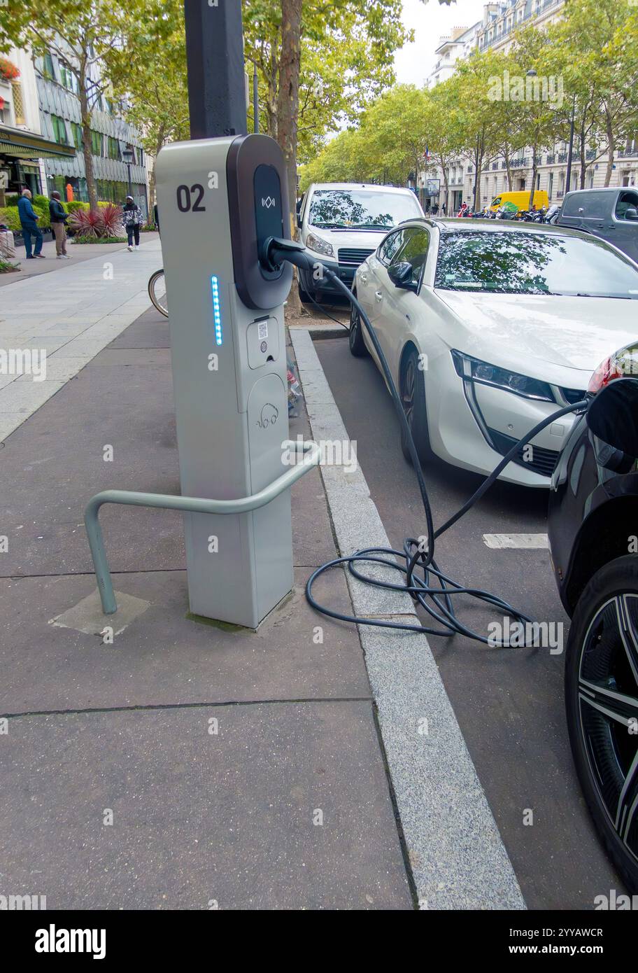 Electric vehicle charging station on pavement Paris, France Stock Photo ...