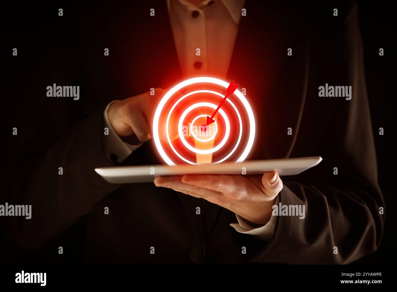 Businessman touching virtual target with arrow over tablet in his hand ...