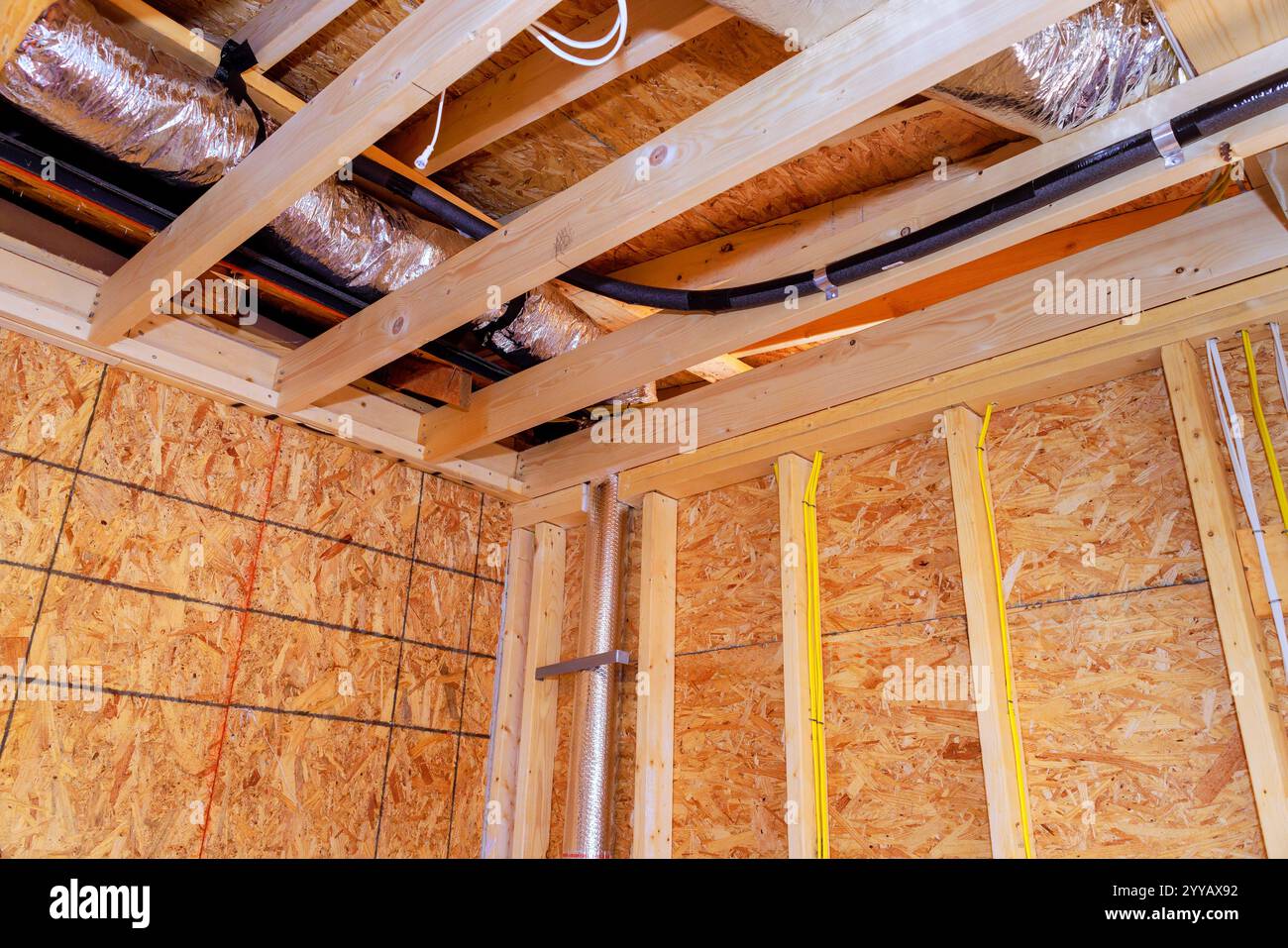 Construction on installing wood framing ductwork in new home under ...
