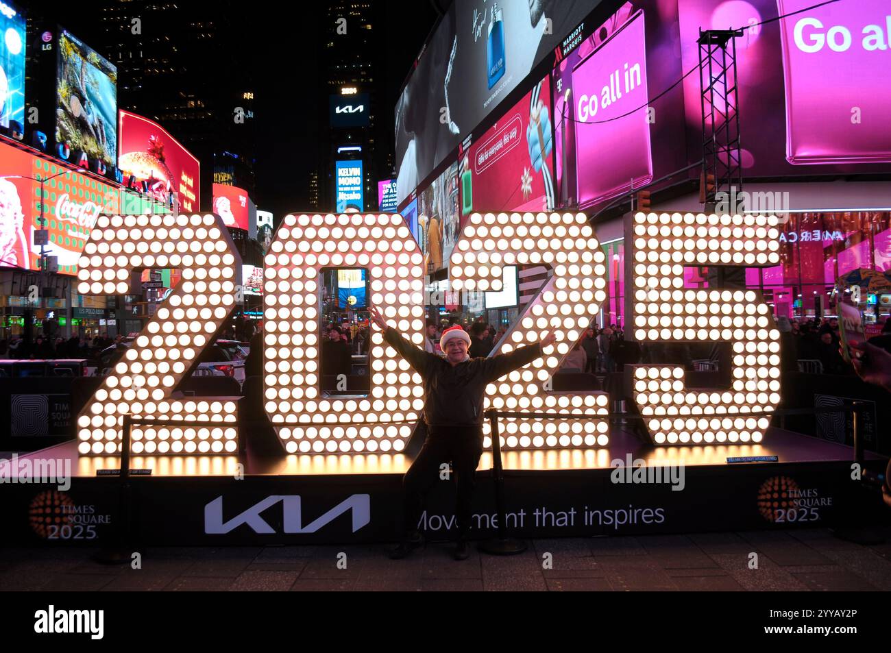 A person poses by the 2025 New Year numerals in Times Square, Manhattan ...