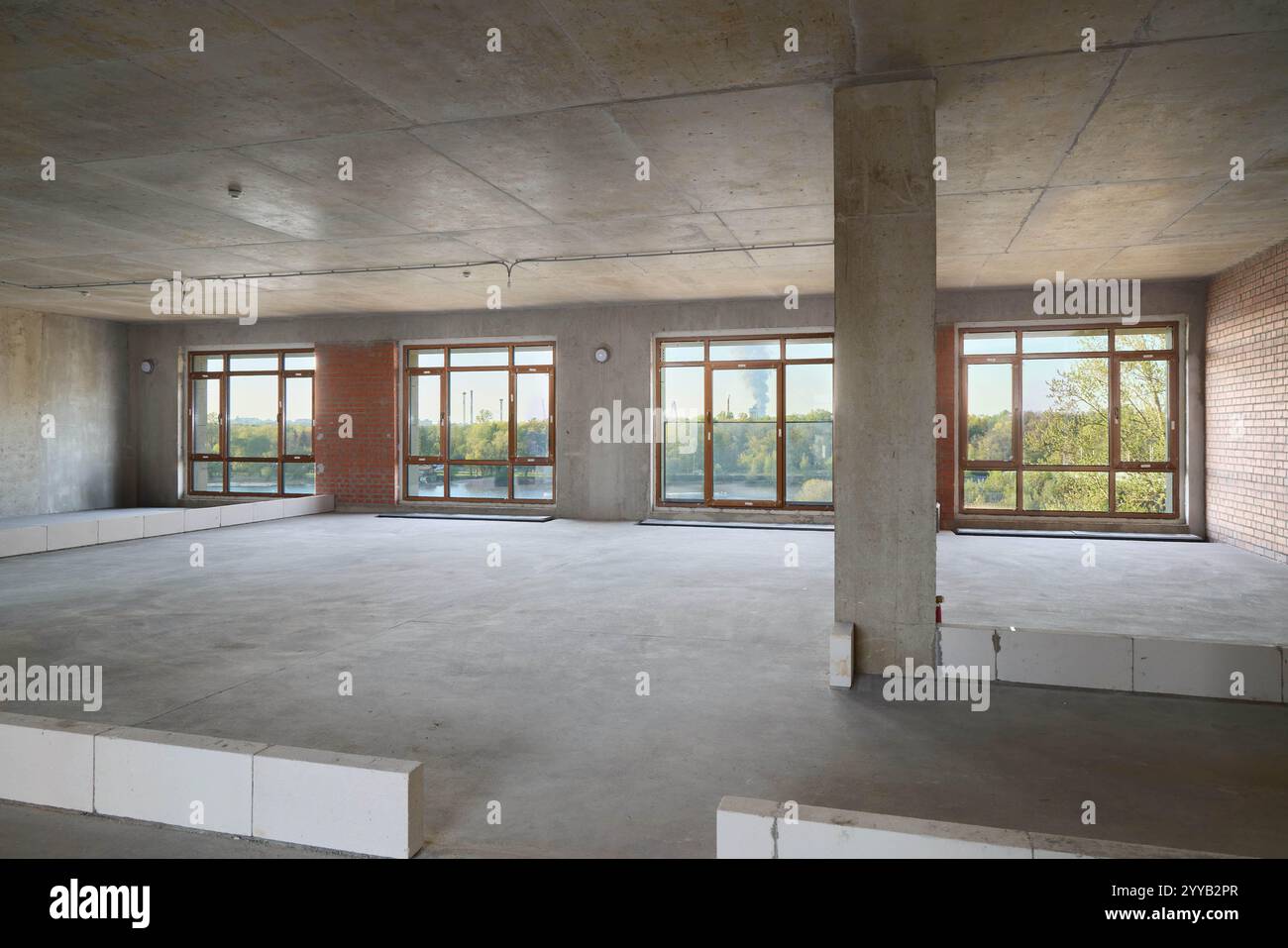 This spacious unfinished interior boasts large windows that allow for ...