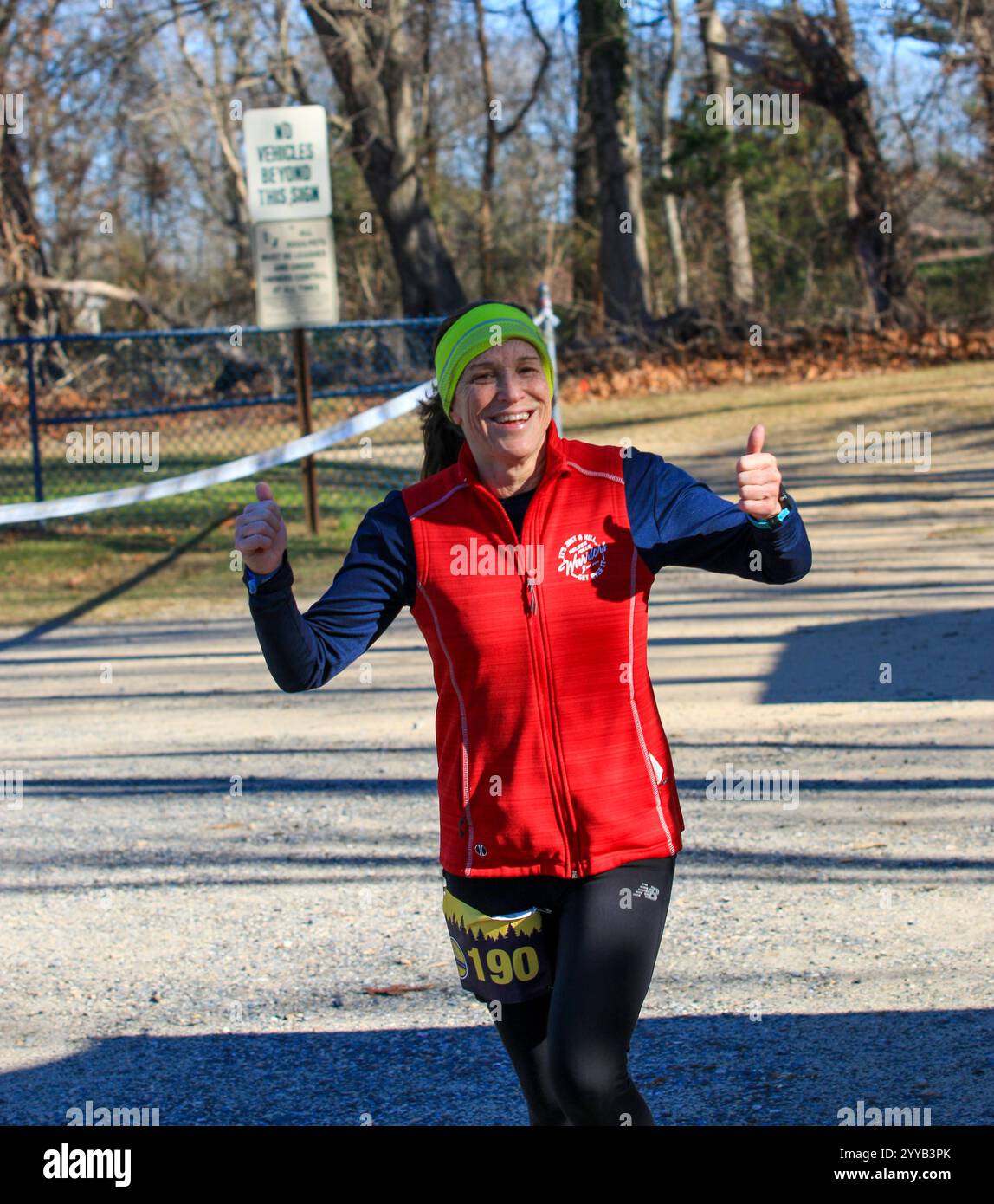 Smithtown, New York, USA - 14 December 2024: A joyful runner gives a ...