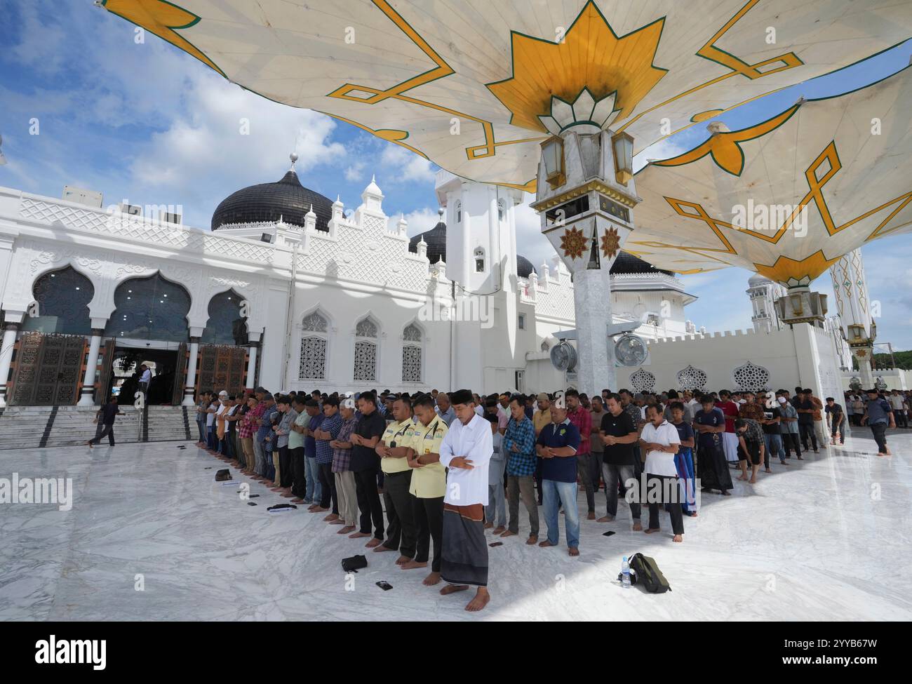 People perform a Friday prayer at Baiturrahman Grand Mosque in Banda ...
