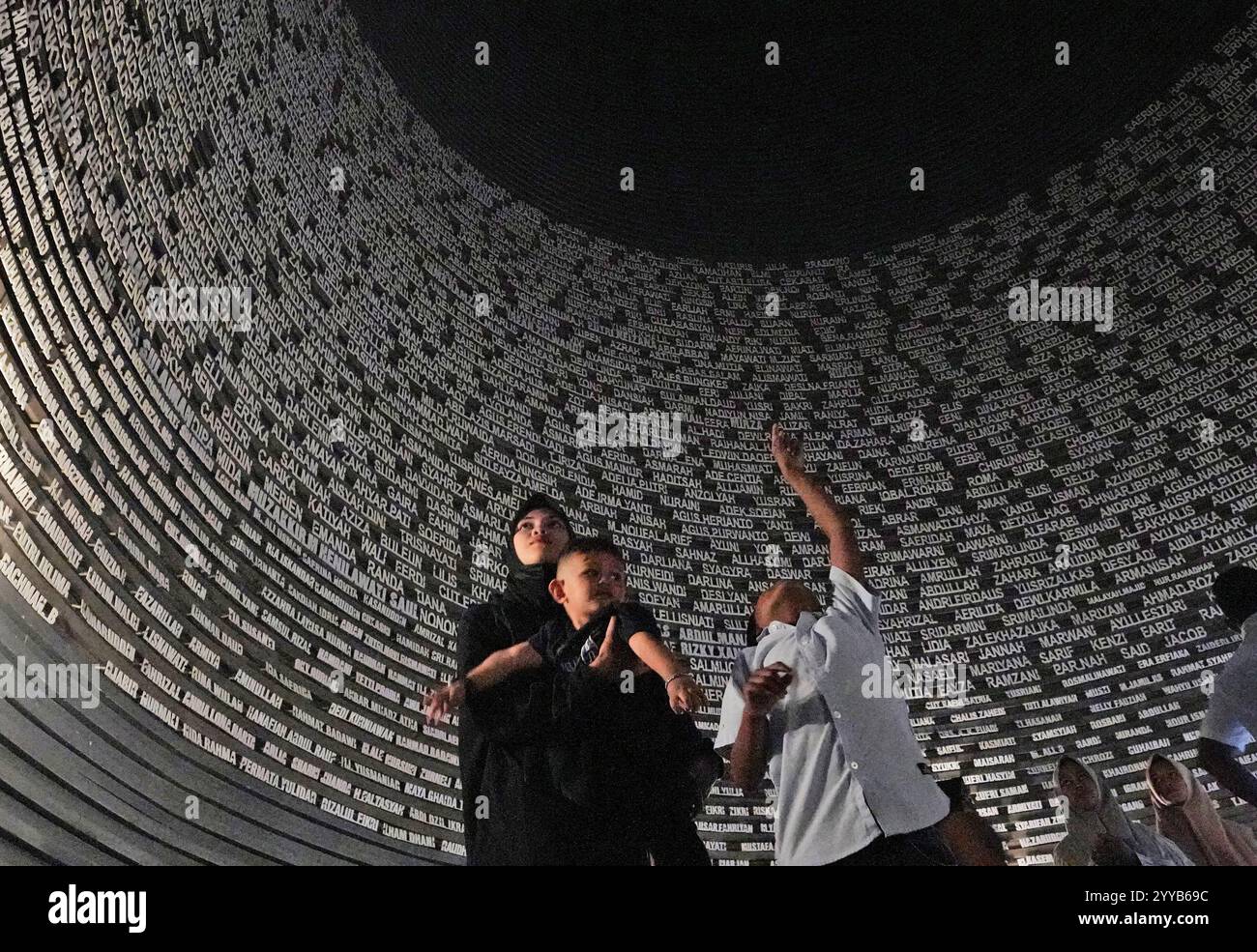 Visitors looks at a wall displaying the names of the victims of 2004 ...