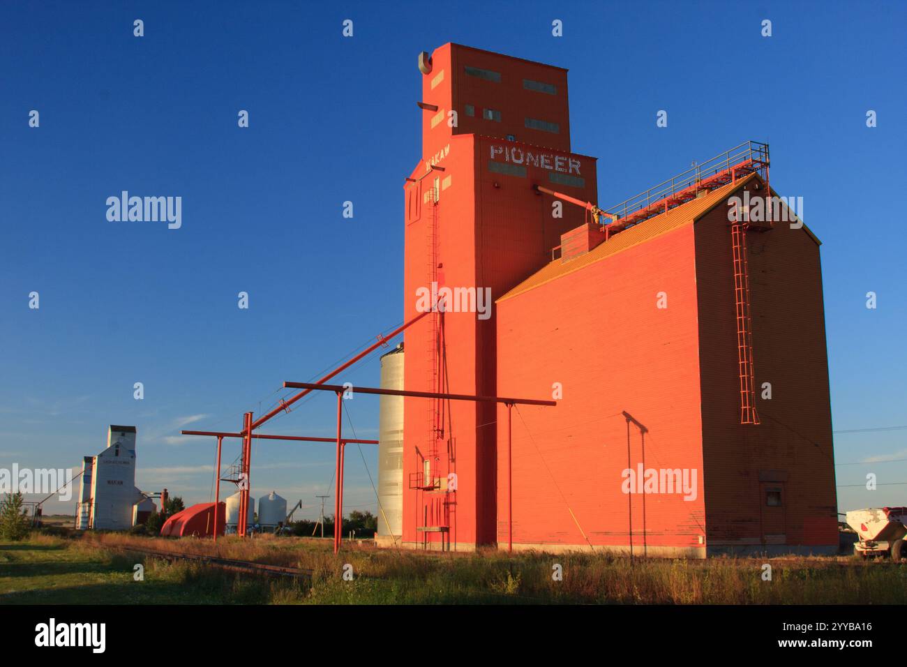 A red grain silo with the word Pioneer on it. The sky is blue and the ...