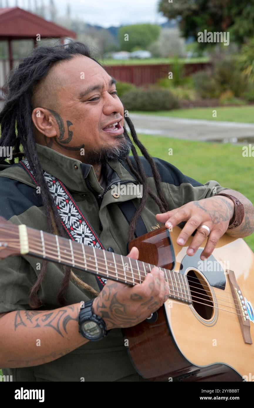 Maori man singing and playing guitar in New Zealand Stock Photo - Alamy
