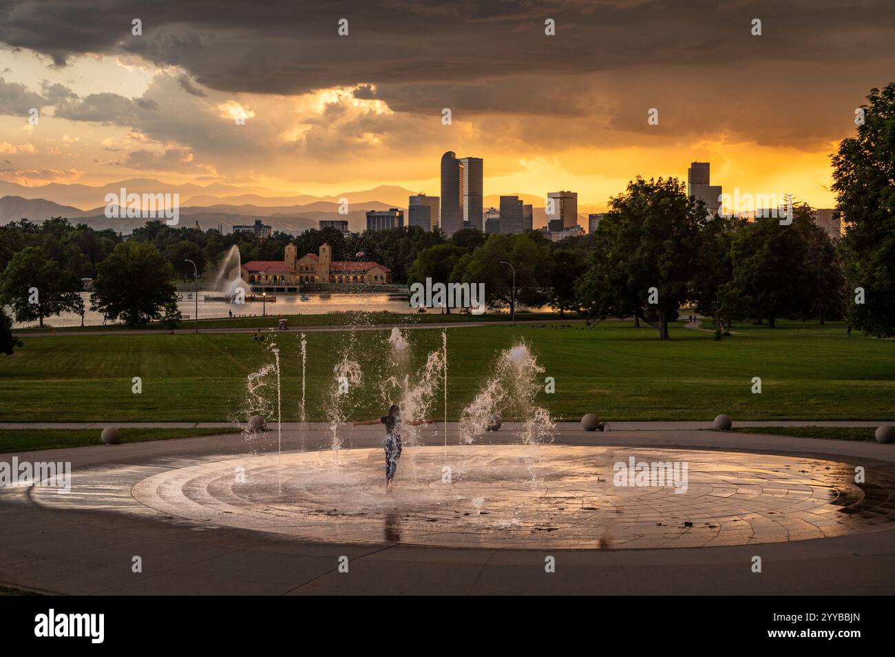 Scenic Sunset Over Park Fountain with City Skyline and Mountains in ...