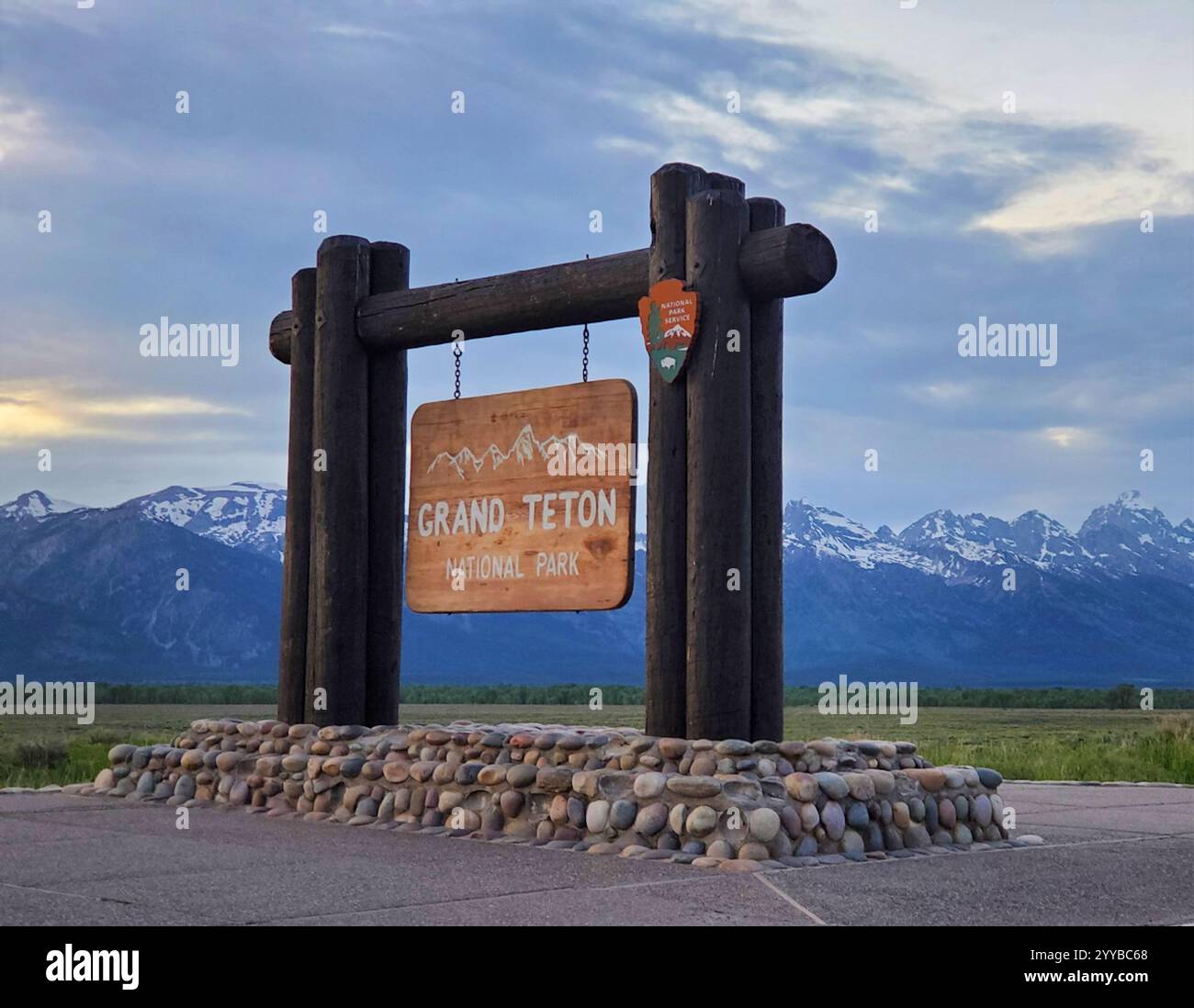 Entrance sign to Grand Teton National Park hanging from massive log ...