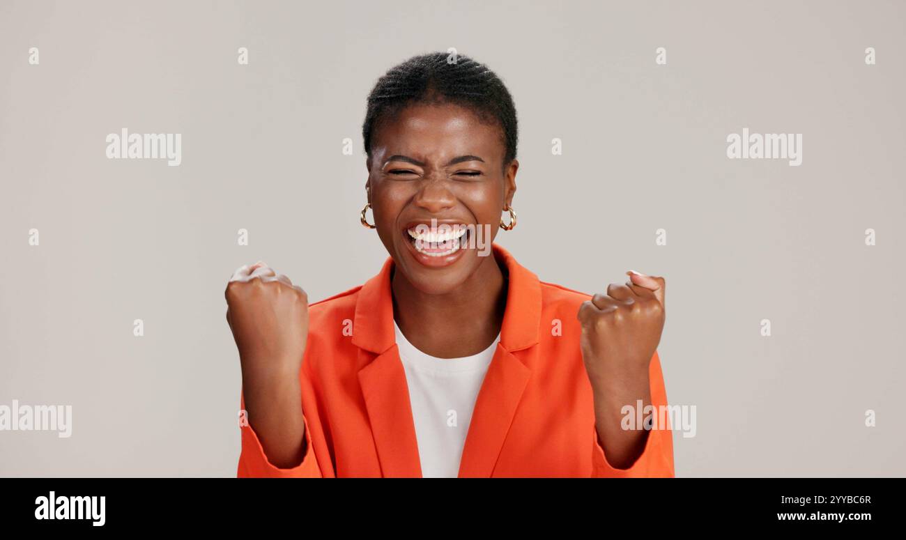 Success, fist and excited black woman in studio for good news, lottery ...