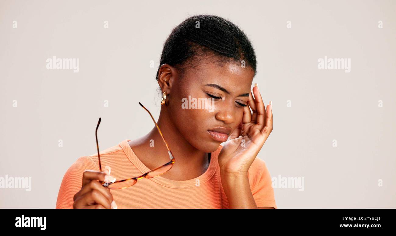Glasses, headache and eye strain with black woman in studio for stress ...