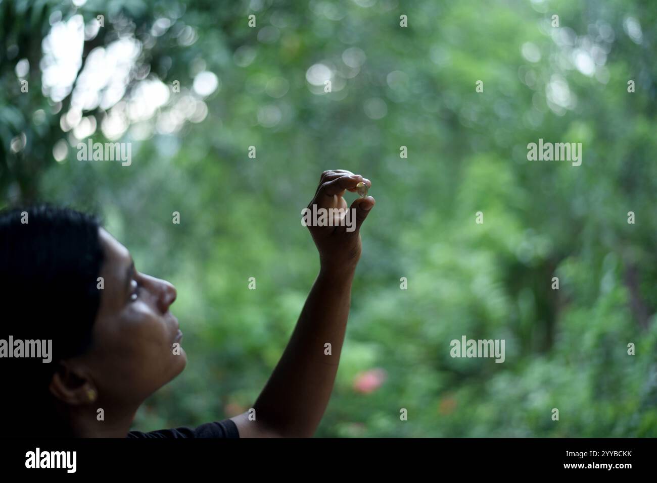 Monaragala, Sri Lanka. 19th Dec, 2024. A woman checks a gemstone in a ...