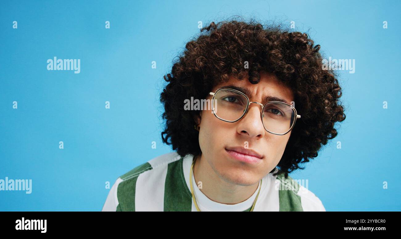Studio, portrait or man with glasses for check, see clear and confused ...