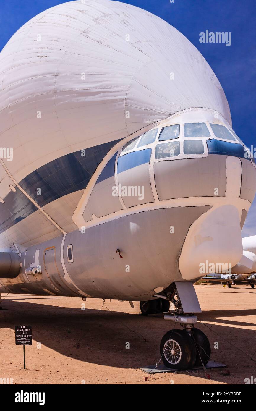 A large white airplane with a blue stripe on the side. The plane is ...